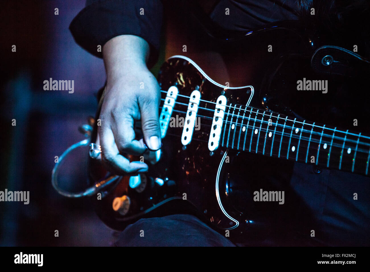 rock musician playing a Fender Stratocaster electric guitar during the ...