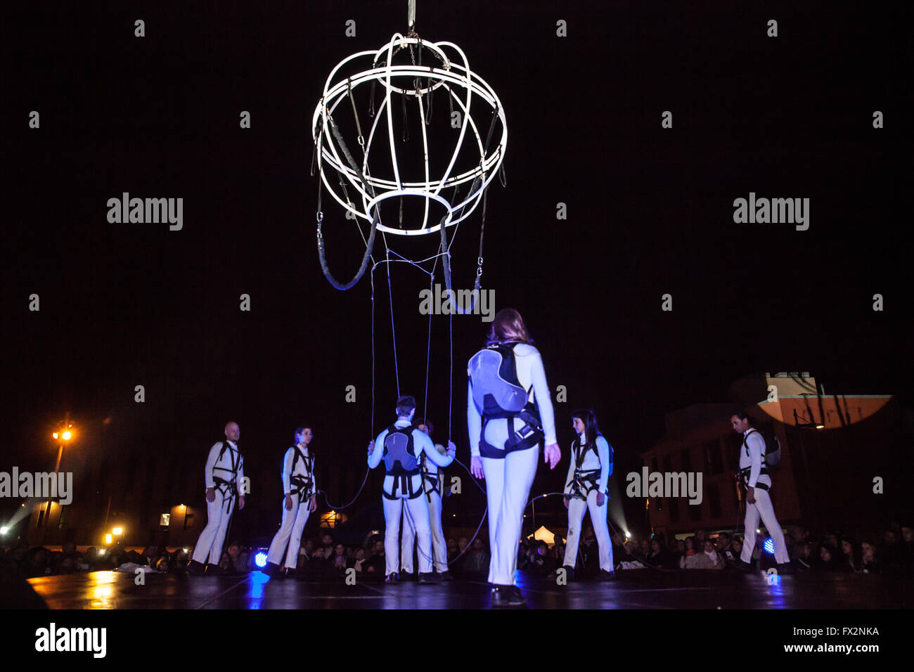 acrobats hanging in the open air at night during the LA NOCHE EN BLANCO ...
