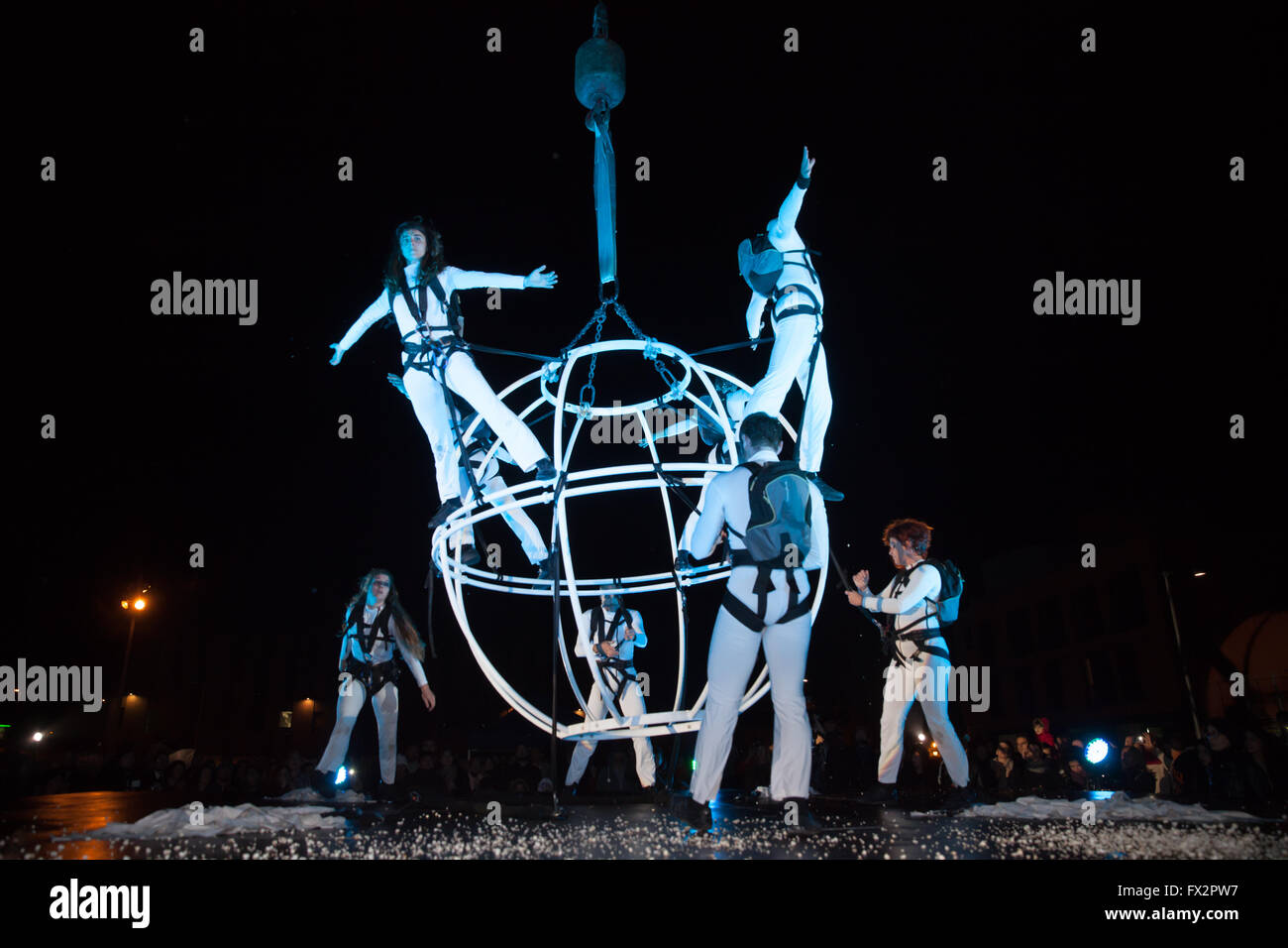 acrobats hanging in the open air at night during the LA NOCHE EN BLANCO ...