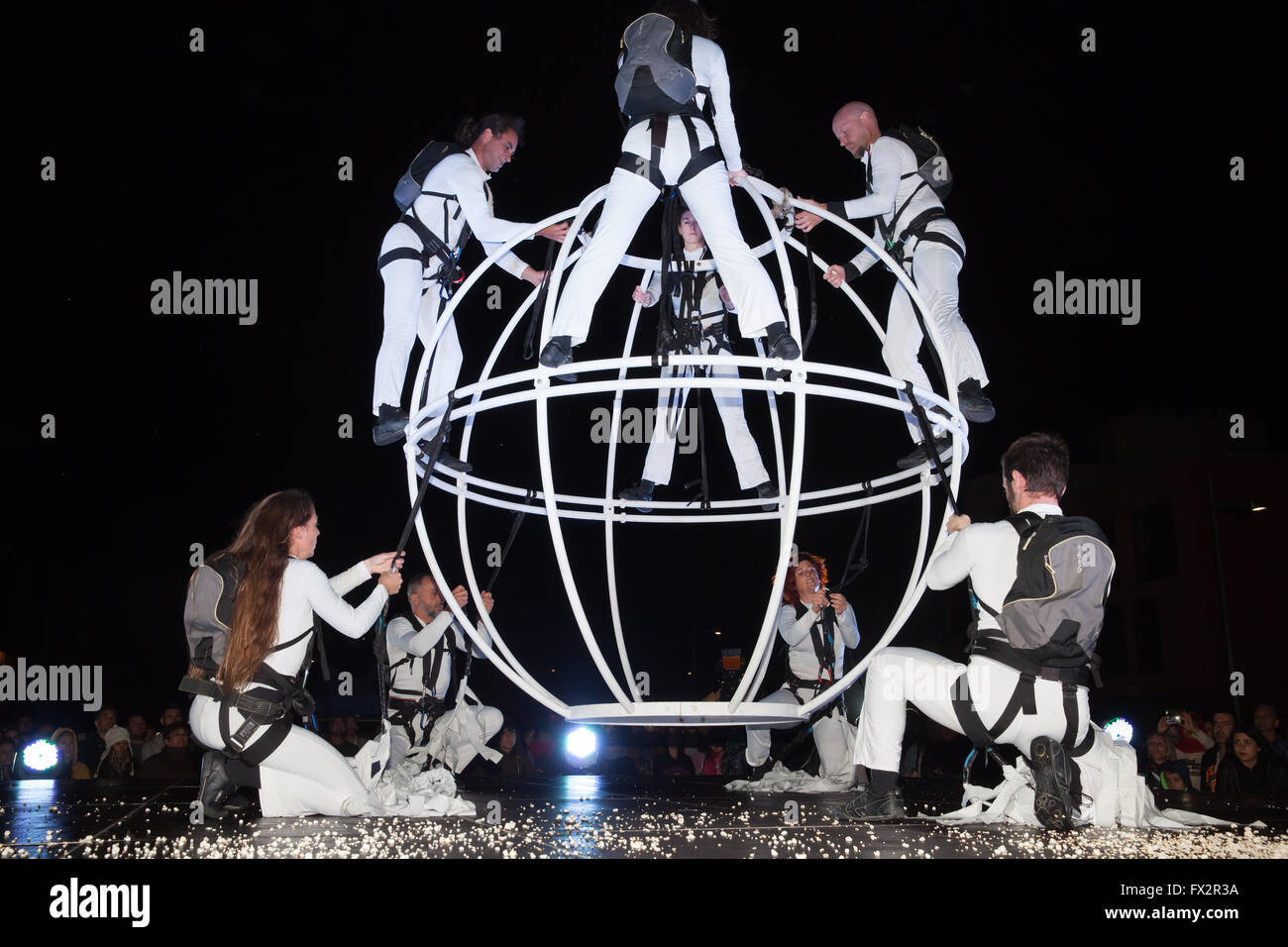 acrobats hanging in the open air at night during the LA NOCHE EN BLANCO ...