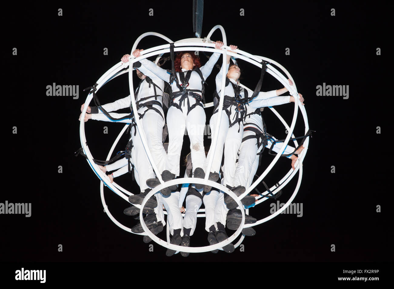 acrobats hanging in the open air at night during the LA NOCHE EN BLANCO ...
