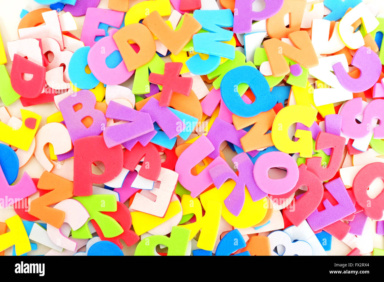 various letters made of foam lying together on a mound Stock Photo - Alamy