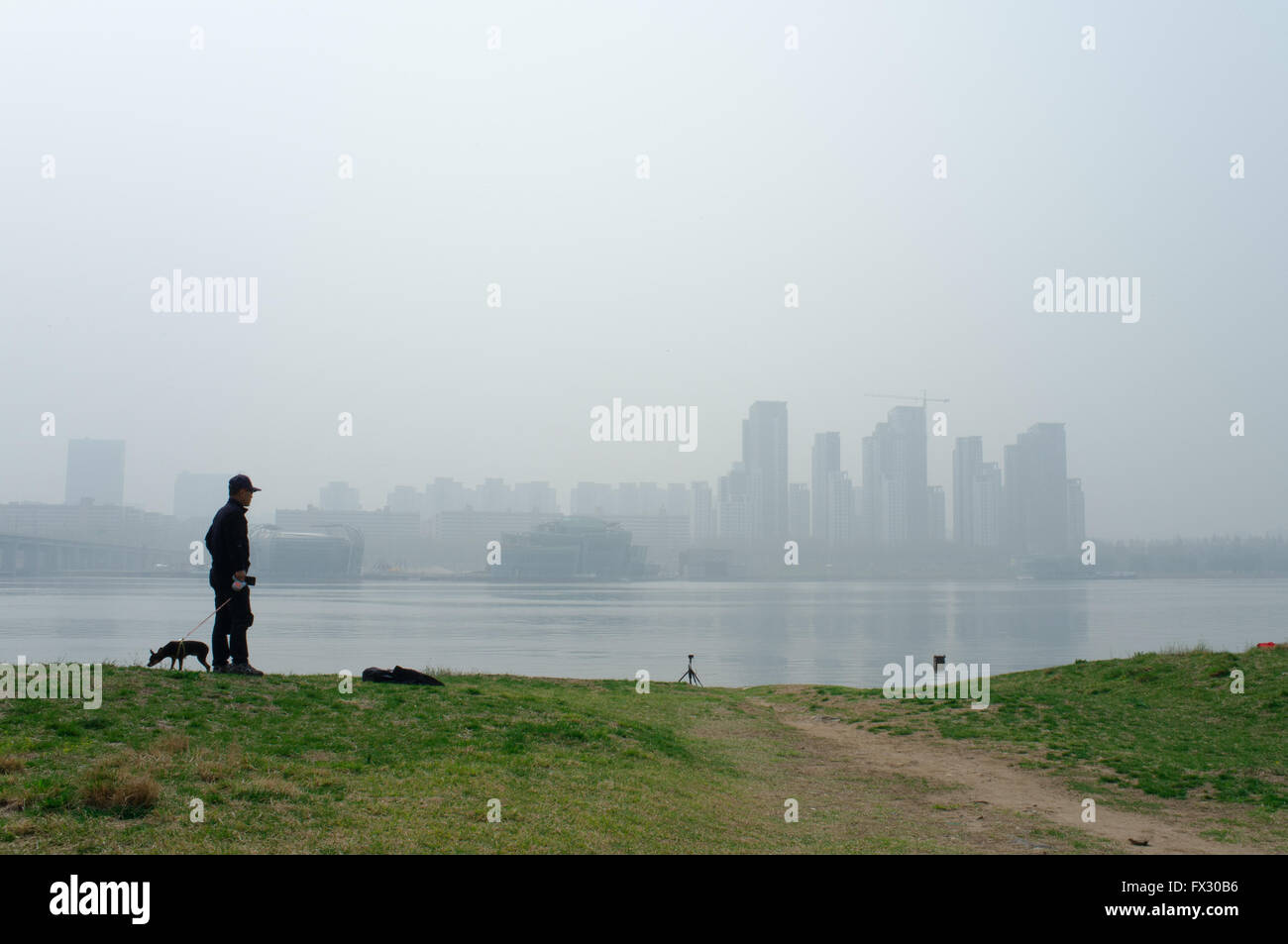 Seoul, South Korea. 10th April, 2016. A man looks across the Han River ...