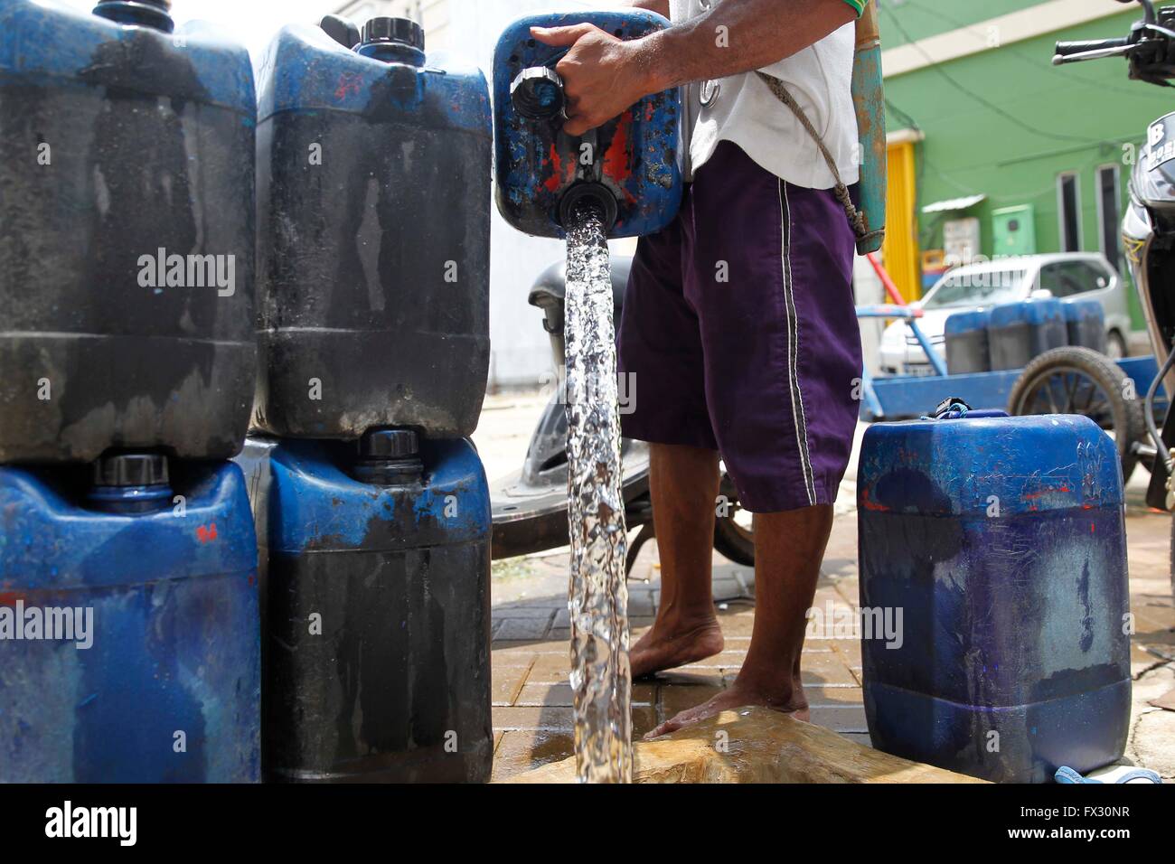 Jakarta, Indonesia. 04th Mar, 2016. A man fills a clean water to a ...