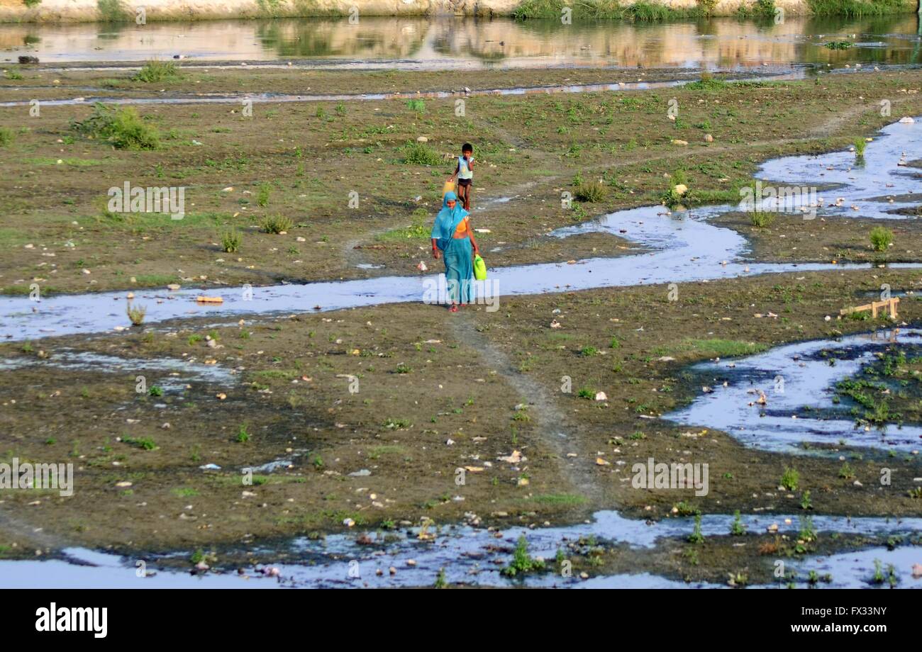 Allahabad, India. 10th Apr, 2016. A women carrying water from a dry ...