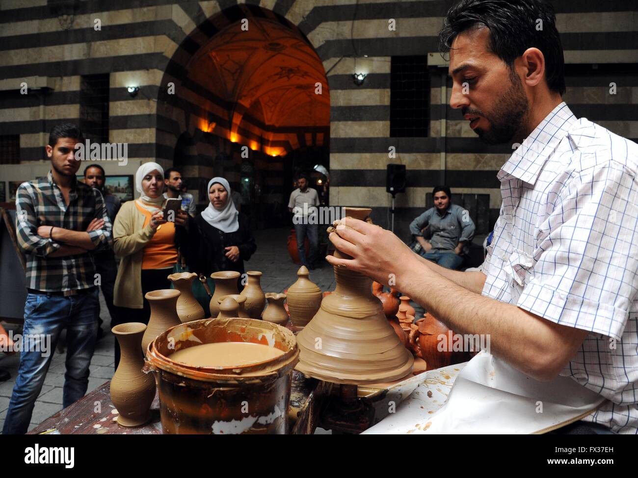 Damascu, Syria. 10th Apr, 2016. A Syrian craftsman makes a clay pot ...