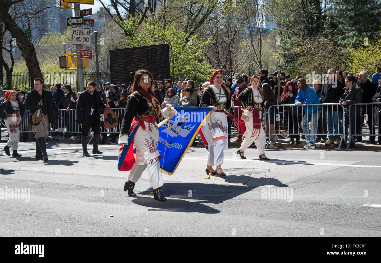 Women wearing traditional Greek dress marching and carrying a banner in ...