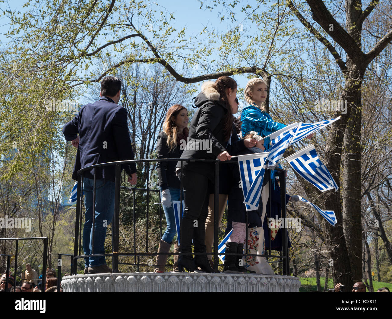 People waving flags from a float in the 2016 New York Greek Parade ...
