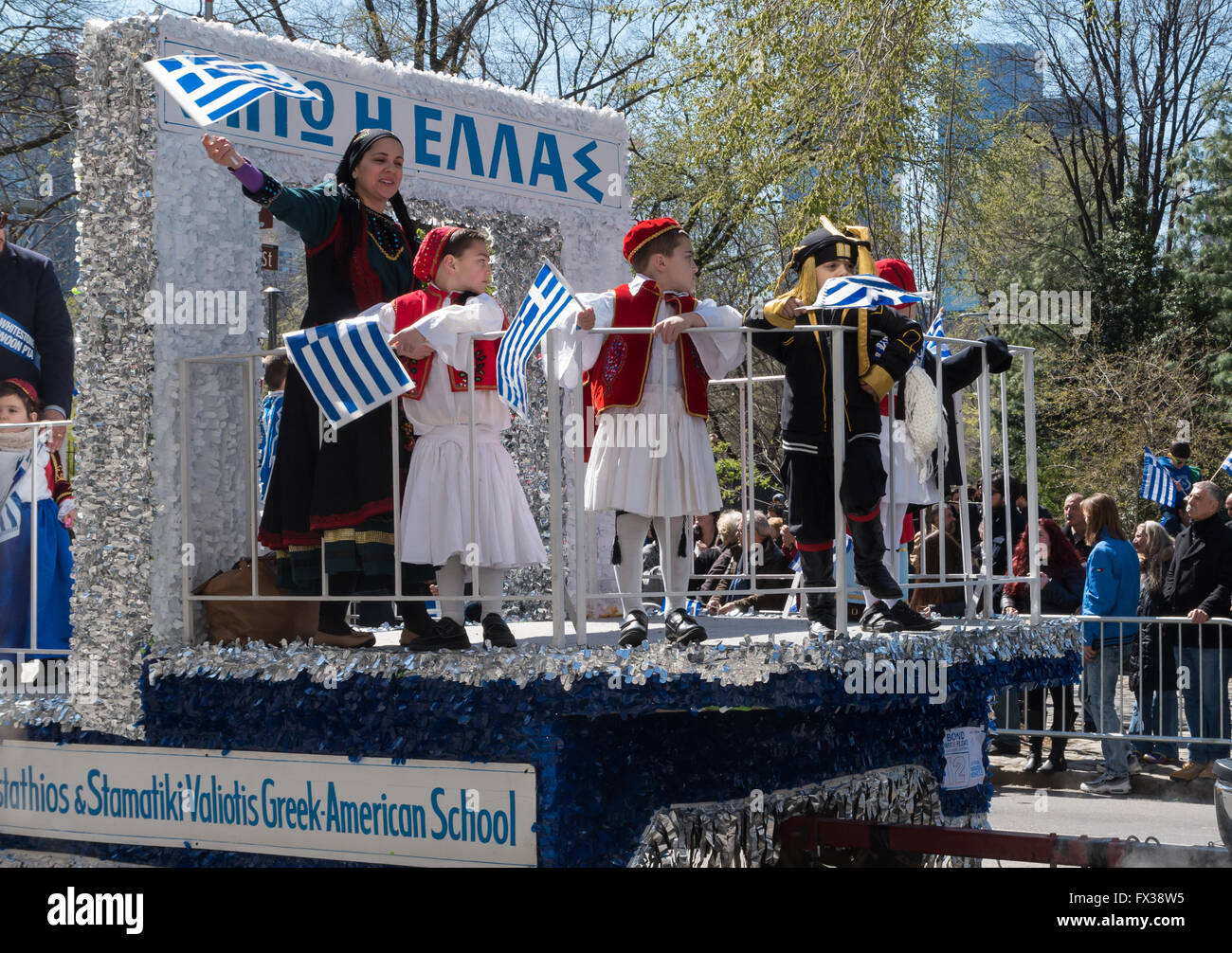 Boys in Greek national dress waving flags from a float in the 2016 New ...