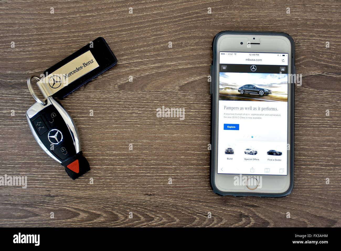 An Apple iPhone displaying the Mercedes-Benz web page while laying next ...