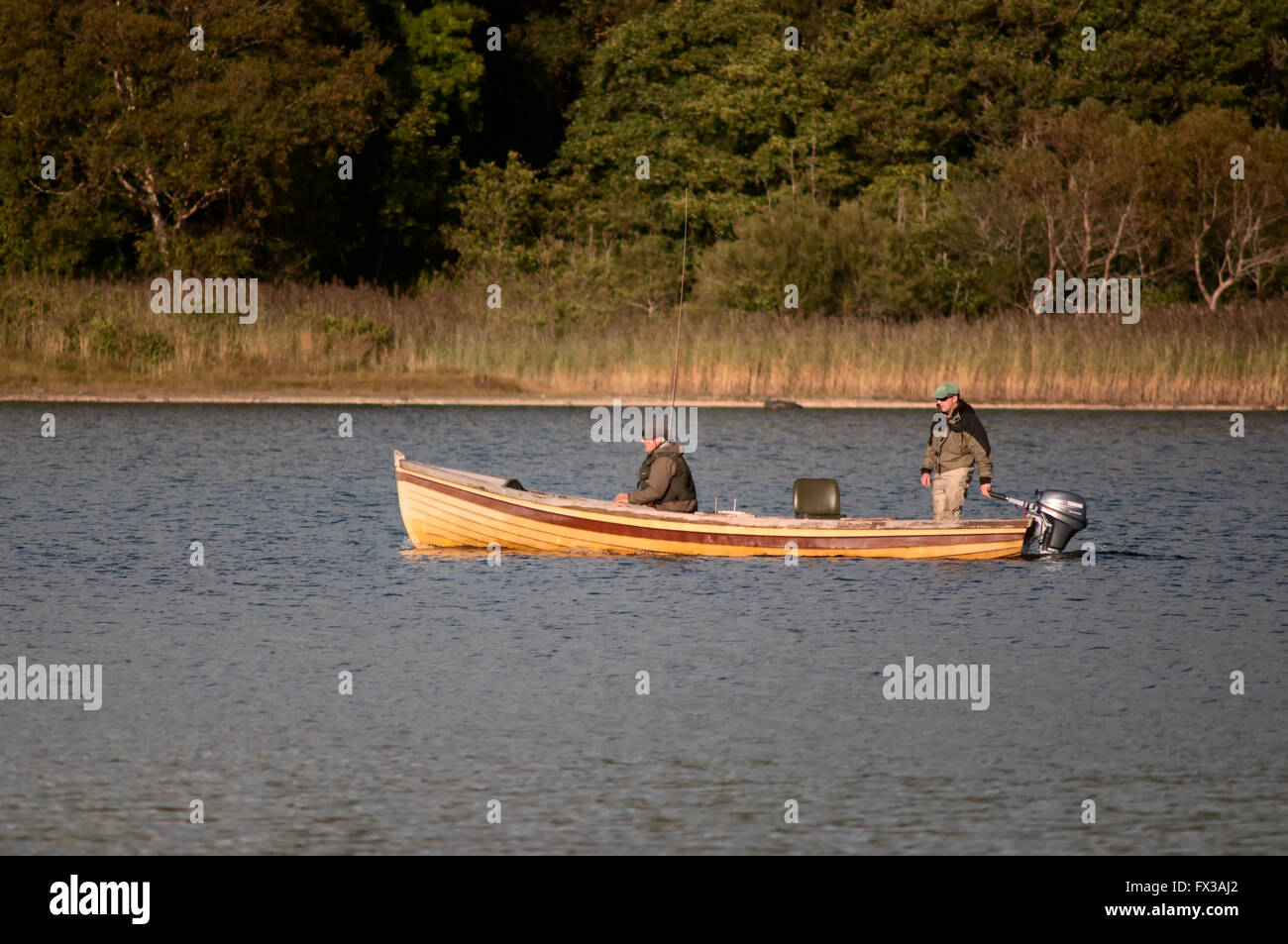 Fishing in Ireland and fishermen in fishing boat or clinker style boat ...