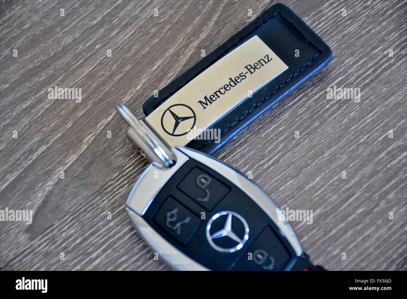 A Mercedes-Benz key fob laying on a wood surface Stock Photo - Alamy