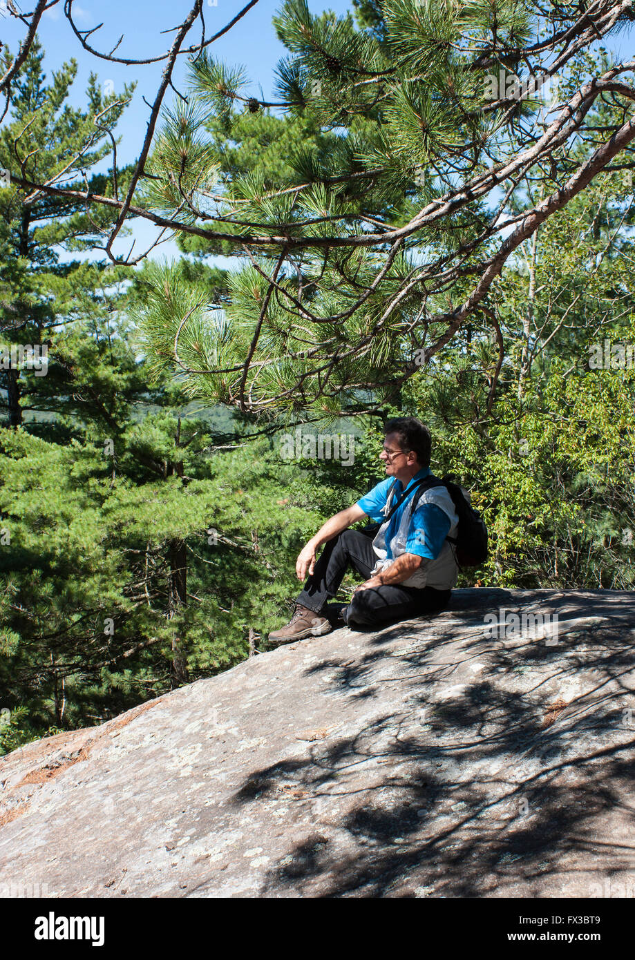 Hiker resting on rocks hi-res stock photography and images - Alamy