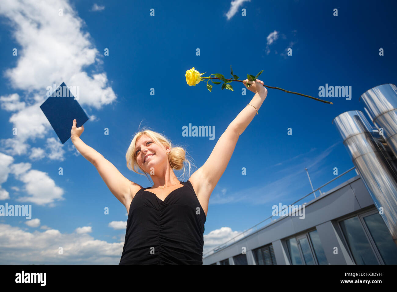 Pretty, young woman celebrating joyfully her graduation - spreading ...
