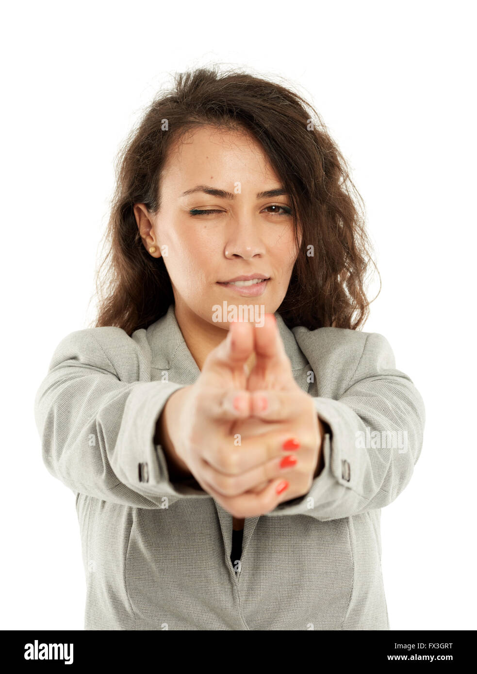 Latin businesswoman aiming at camera with imaginary gun and shooting ...
