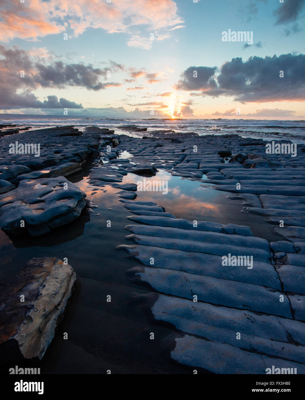 Sunset on the rocky Jurassic limestone beach of the Glamorgan coast ...