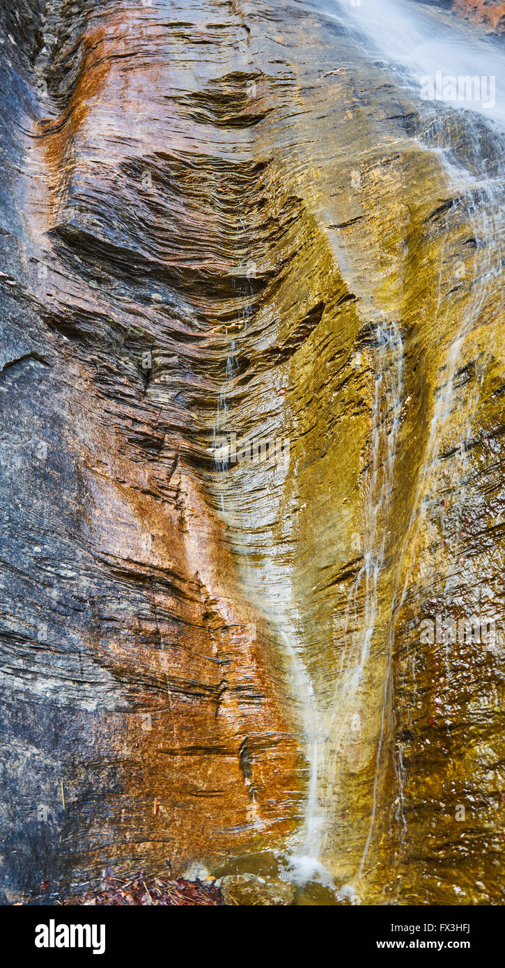 Landscape with a waterfall on colorful rocks Stock Photo - Alamy