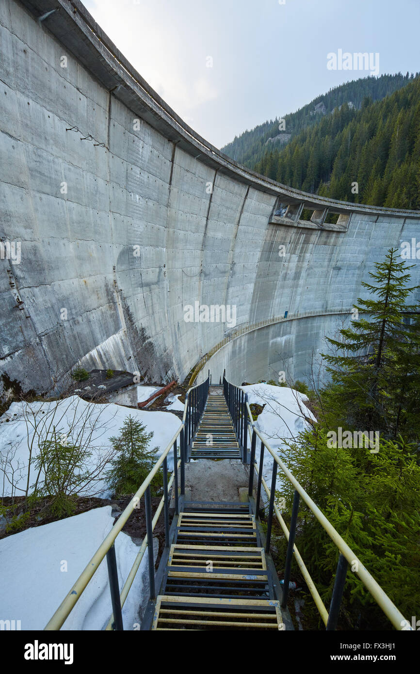 Wide view of a concrete dam in the mountains Stock Photo - Alamy