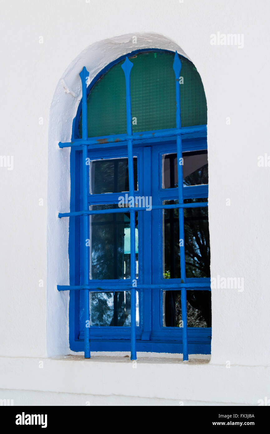 Traditional old blue painted greek window with bars Stock Photo - Alamy