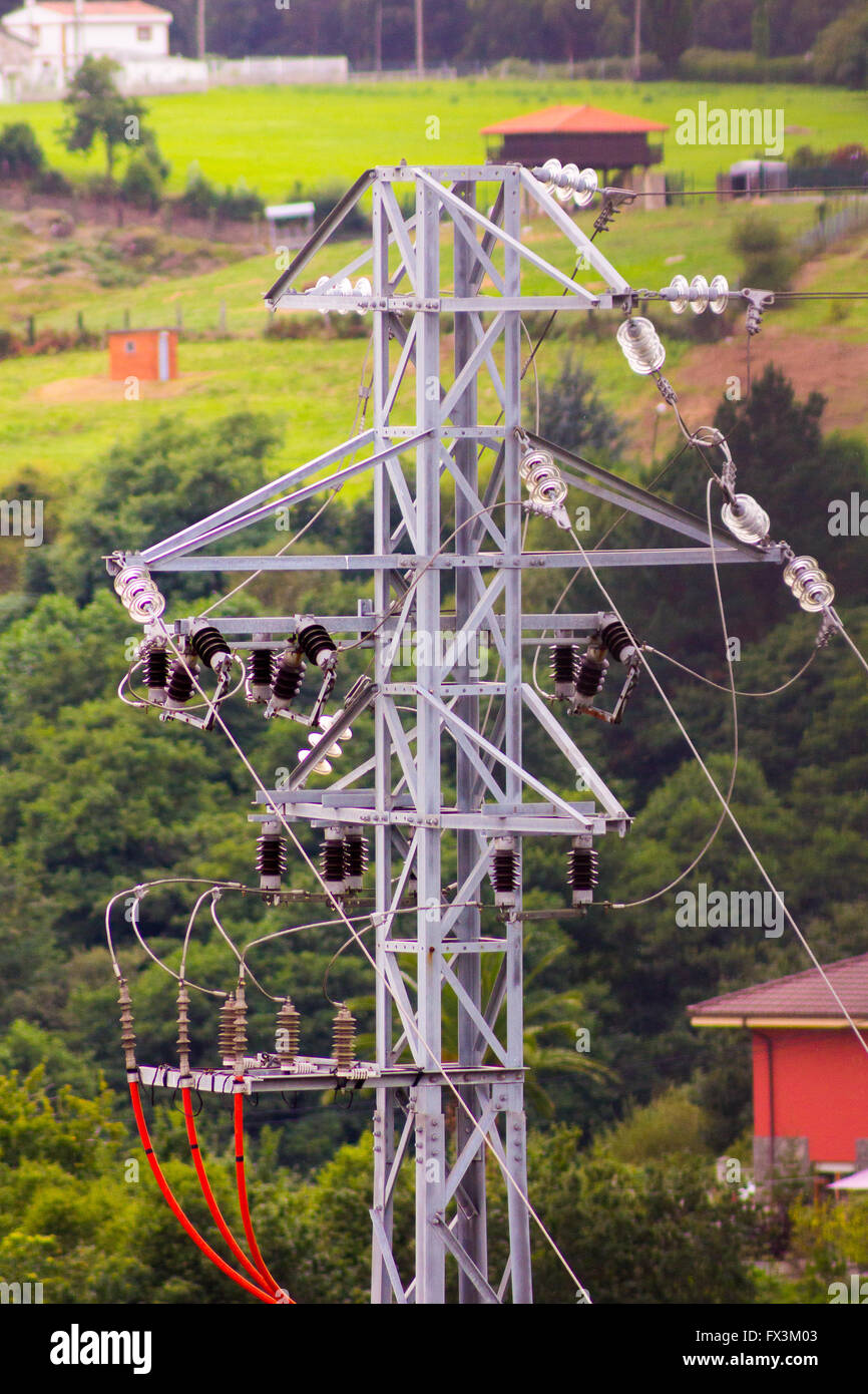 Modern electric pylon on a green field Stock Photo - Alamy