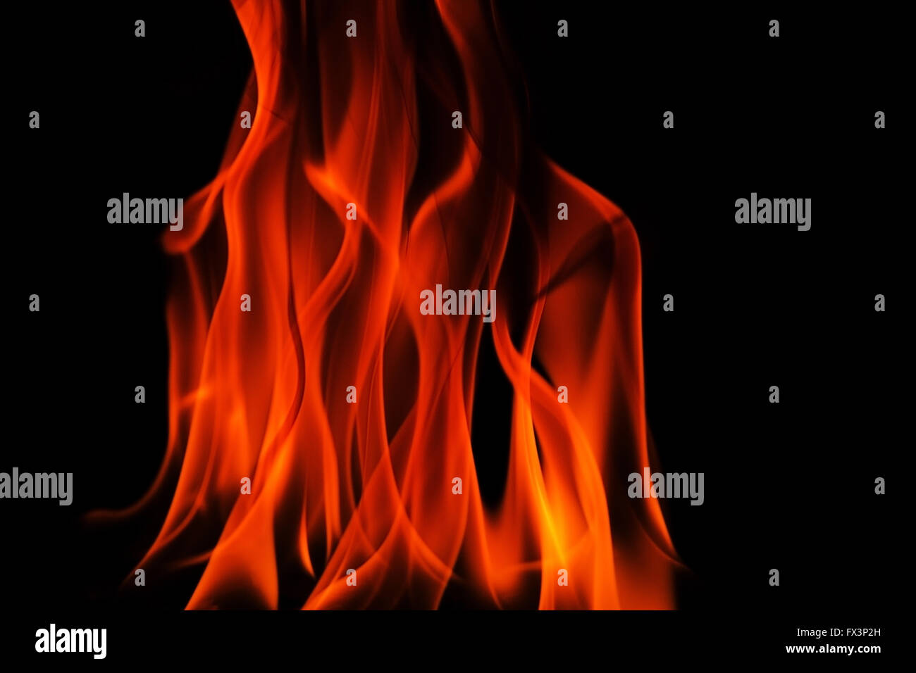 Close view on wall of fire with tonques of fire isolated black ...