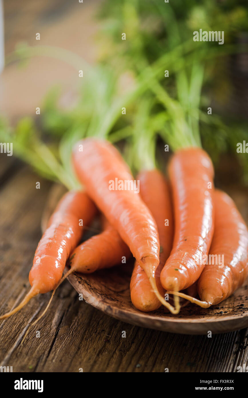 Farm fresh spring carrot, on wooden farmhouse kitchen table Stock Photo ...