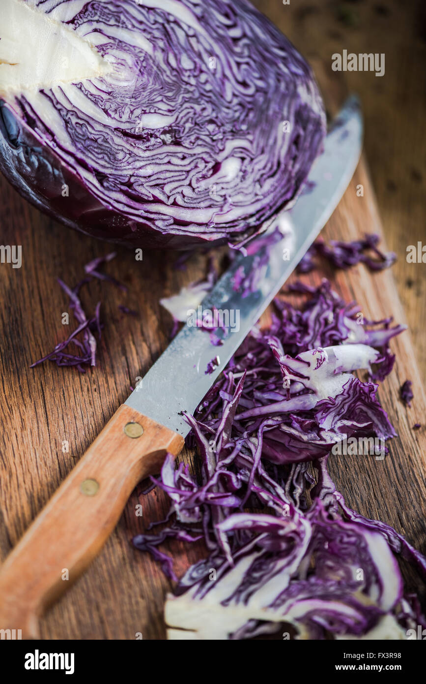 Red cabbage sliced on farmhouse kitchen table. Clean eating concept ...