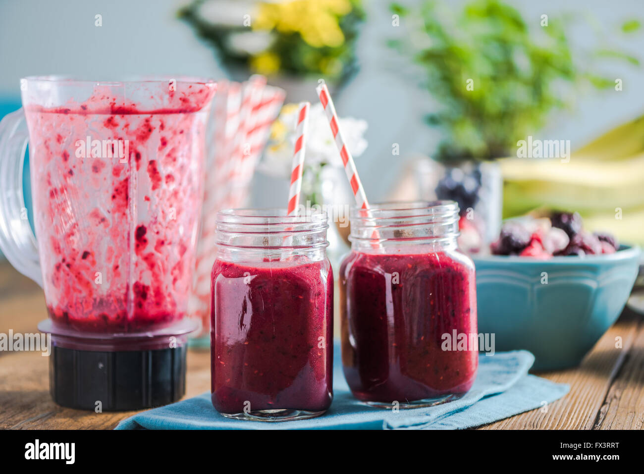 Freshly blended smoothie, in sunny kitchen on farmhouse table. Negative ...