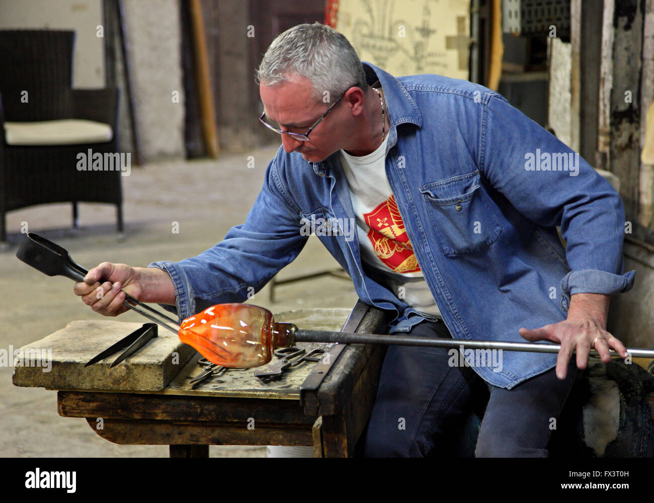 In a glass workshop ("Fornace") in Murano island, Venice, Veneto, Italy ...