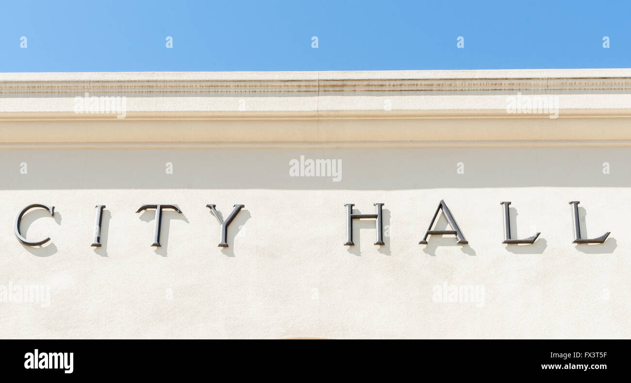 City Hall sign on exterior beige colored wall with blue sky Stock Photo ...