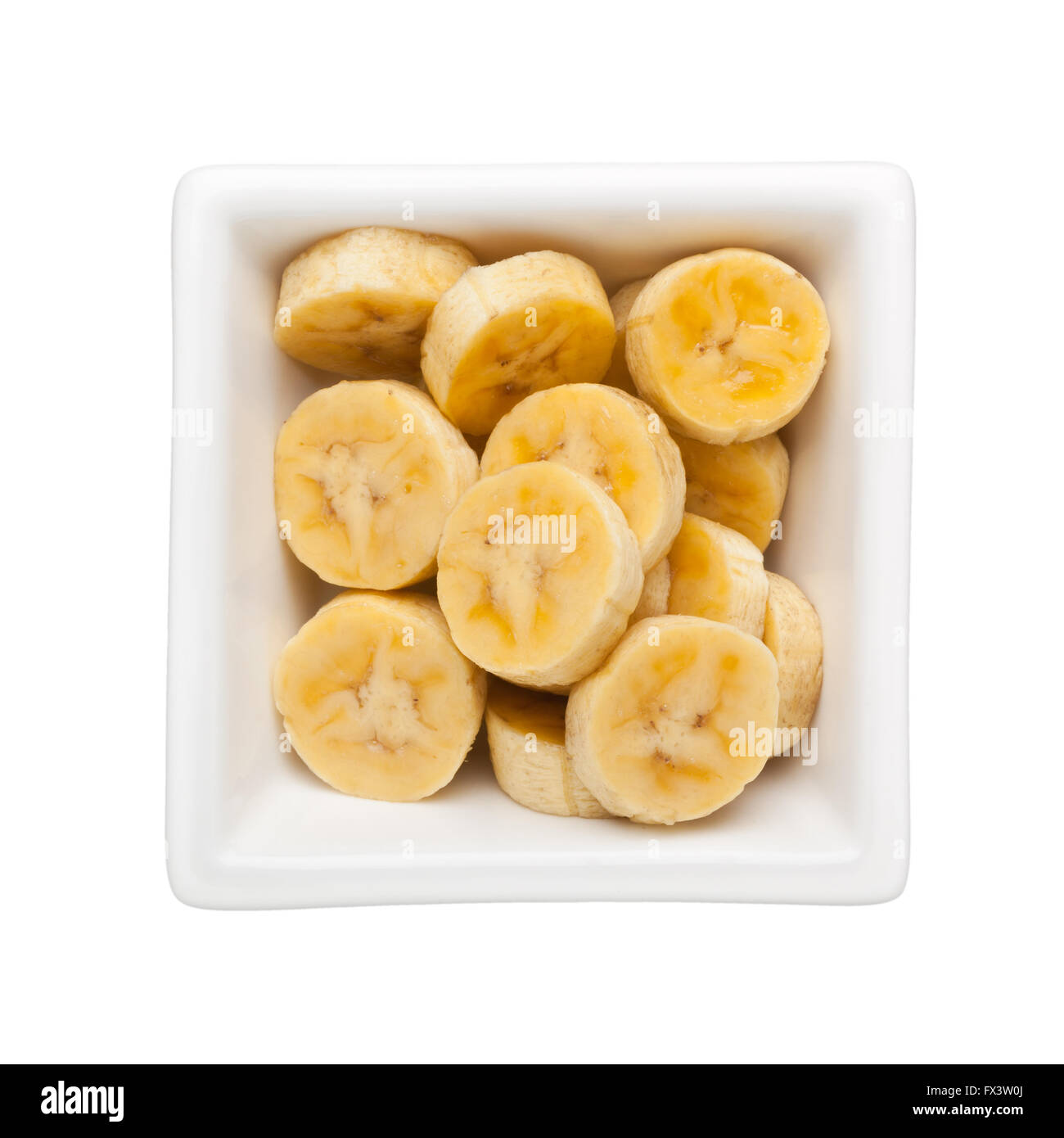 Sliced banana in a square bowl isolated on white background Stock Photo ...