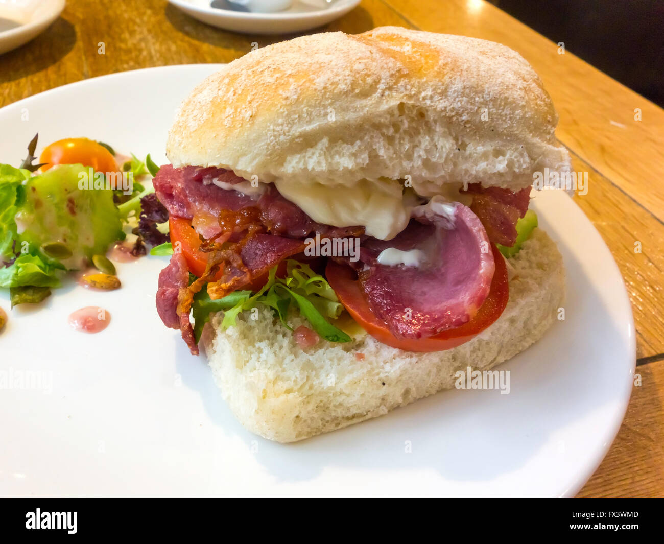 Classic BLT white bun with bacon lettuce tomato mayonnaise and salad ...
