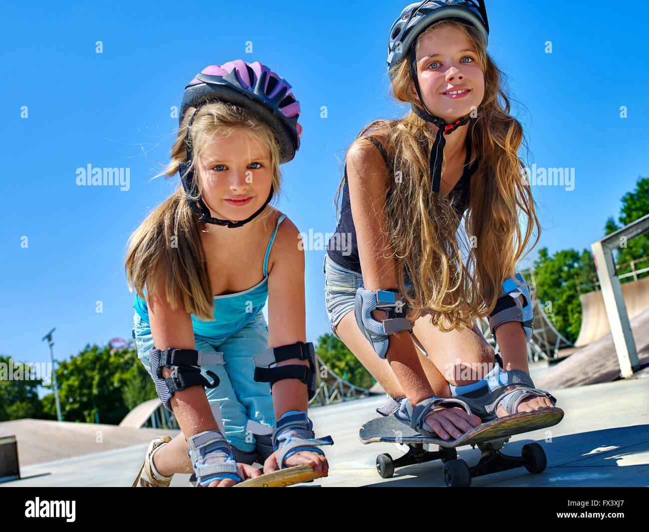 Two girls rides on the skateboard Stock Photo - Alamy
