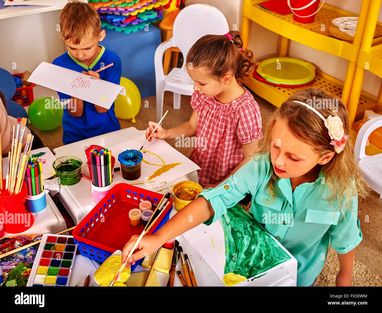 Group of children draws pictures in the small kindergarten Stock Photo ...