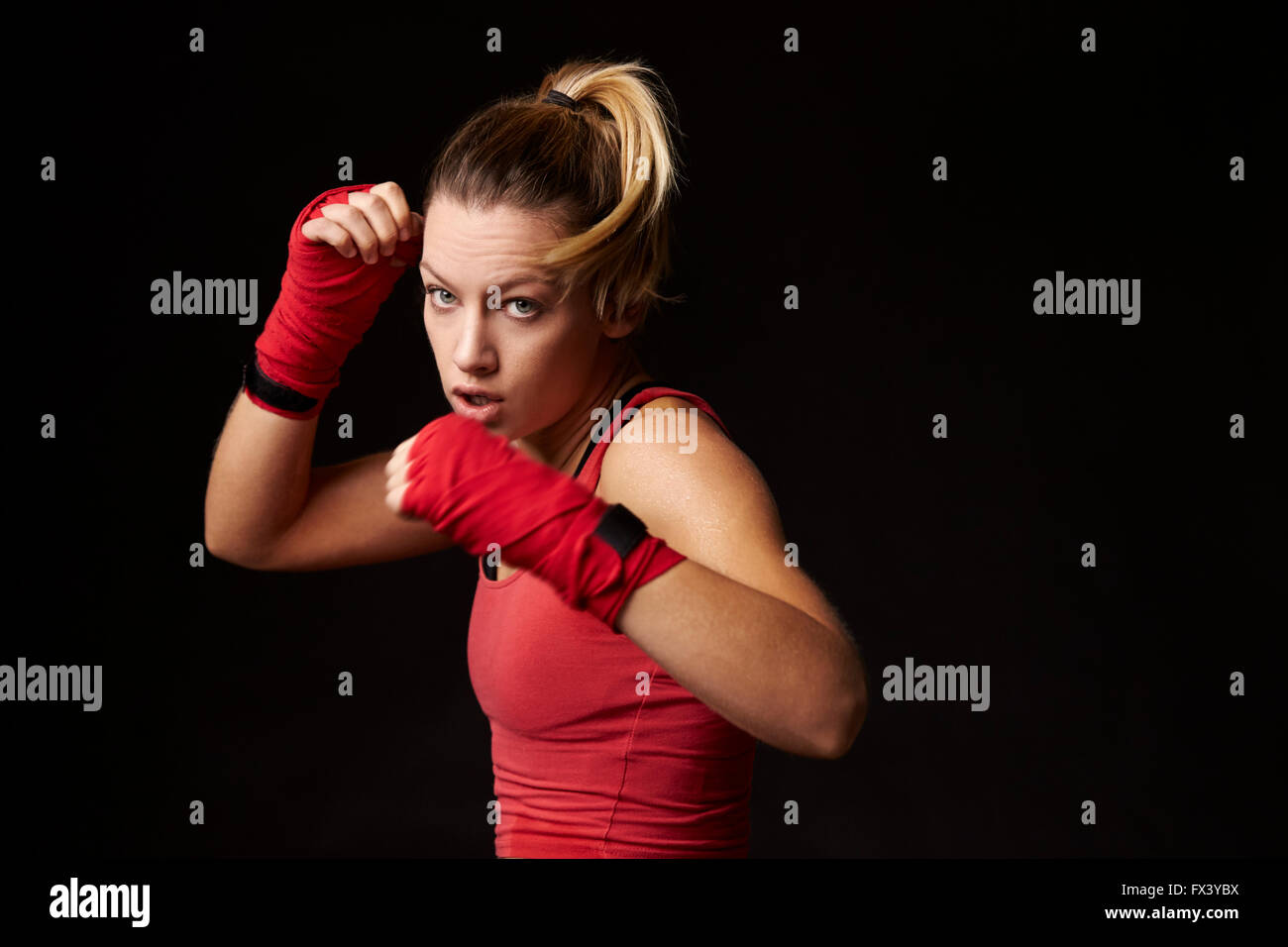 Young blonde woman shadow boxing, in a blocking position Stock Photo ...