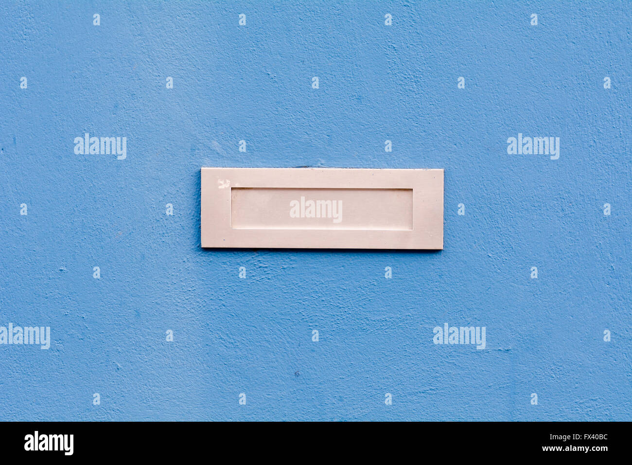 Letterbox in blue painted wall Stock Photo - Alamy
