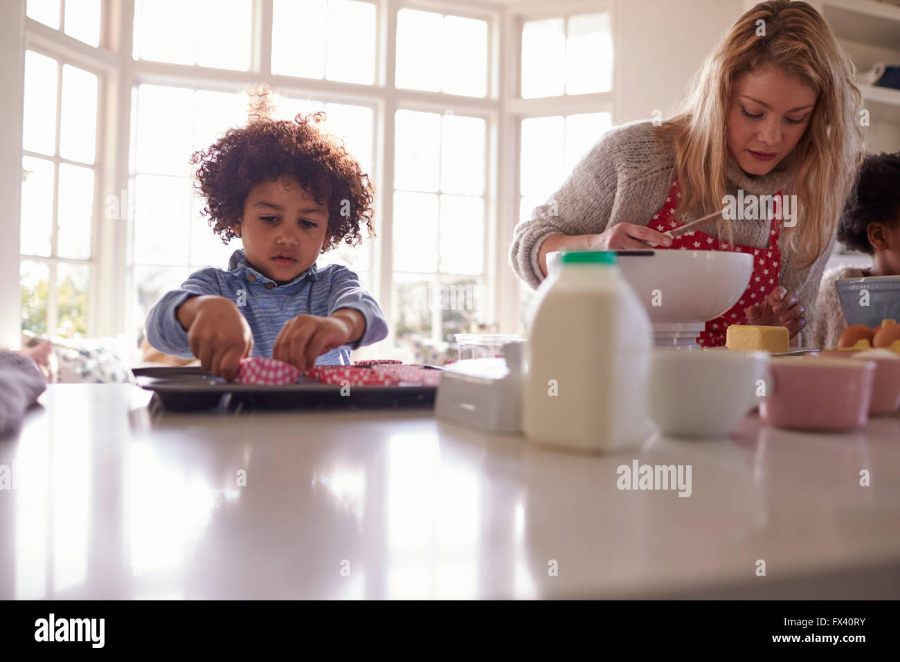 Mother Baking Cake With Children In Kitchen At Home Stock Photo - Alamy