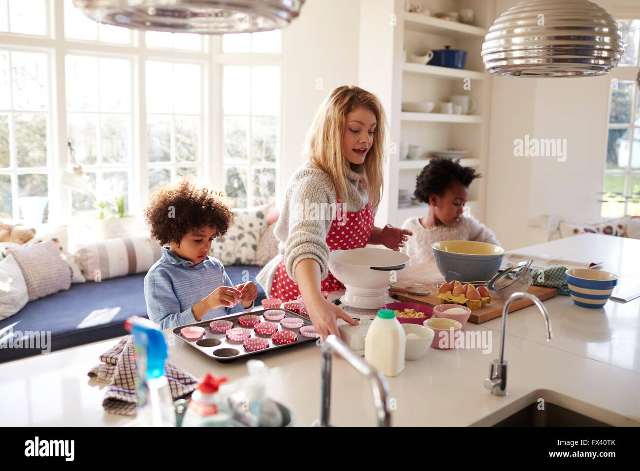 Mother Baking Cake With Children In Kitchen At Home Stock Photo - Alamy