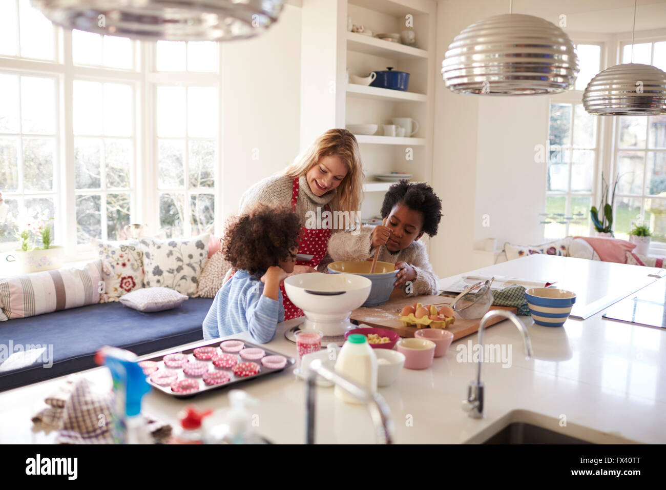 Mother Baking Cake With Children In Kitchen At Home Stock Photo - Alamy