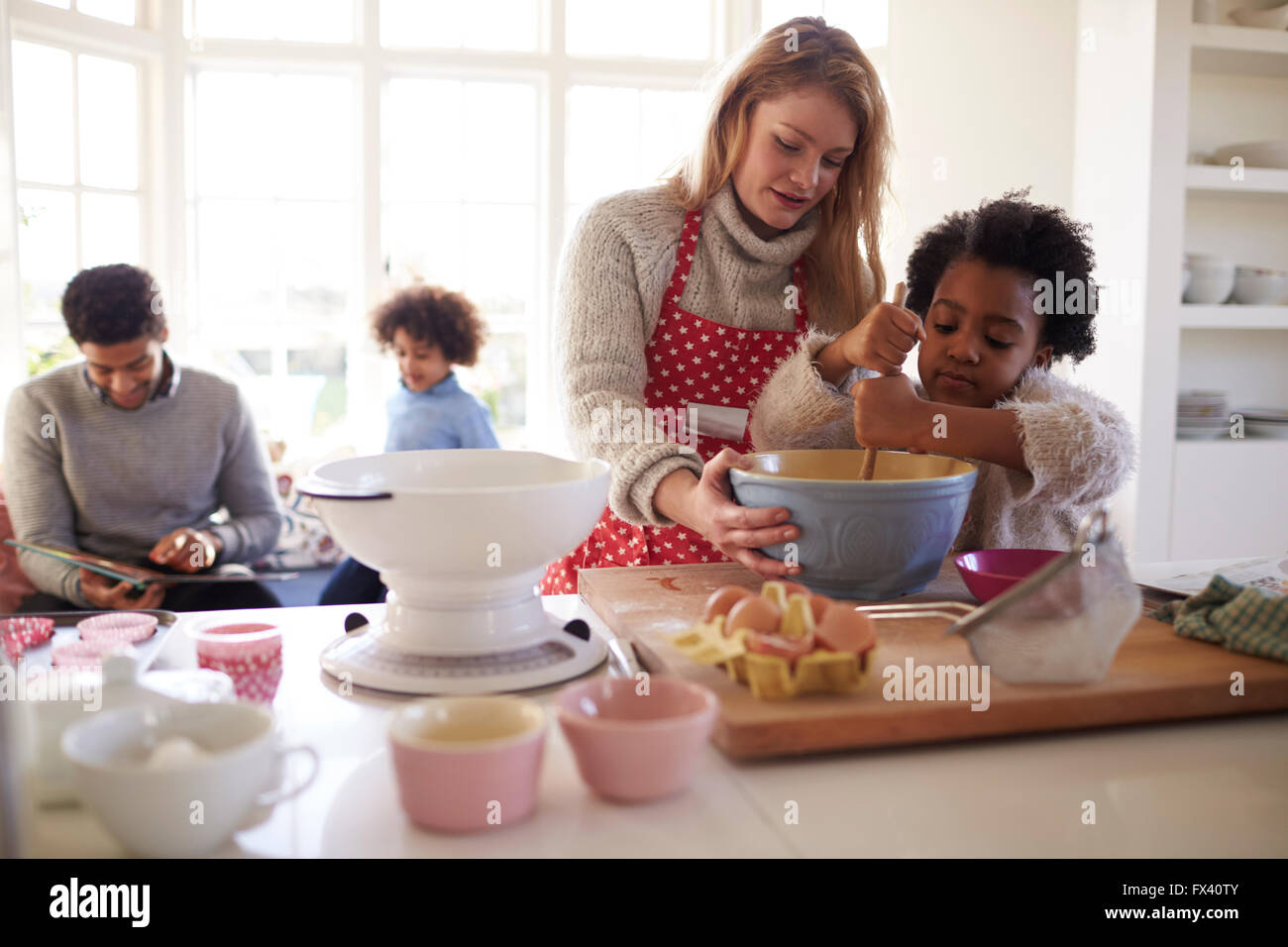 African boy helping mother baking cake hi-res stock photography and ...