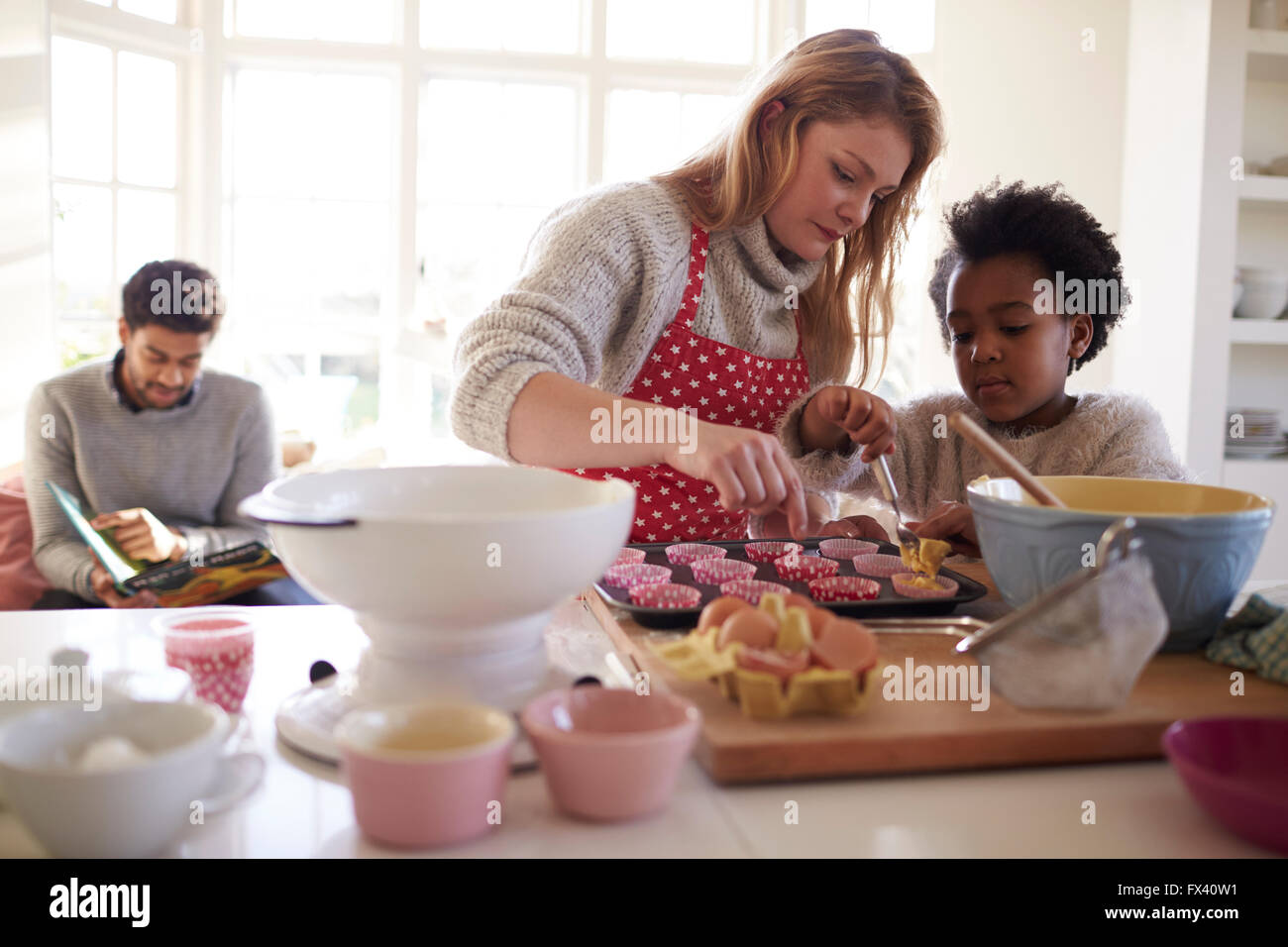 Family Baking Cake In Kitchen At Home Together Stock Photo - Alamy