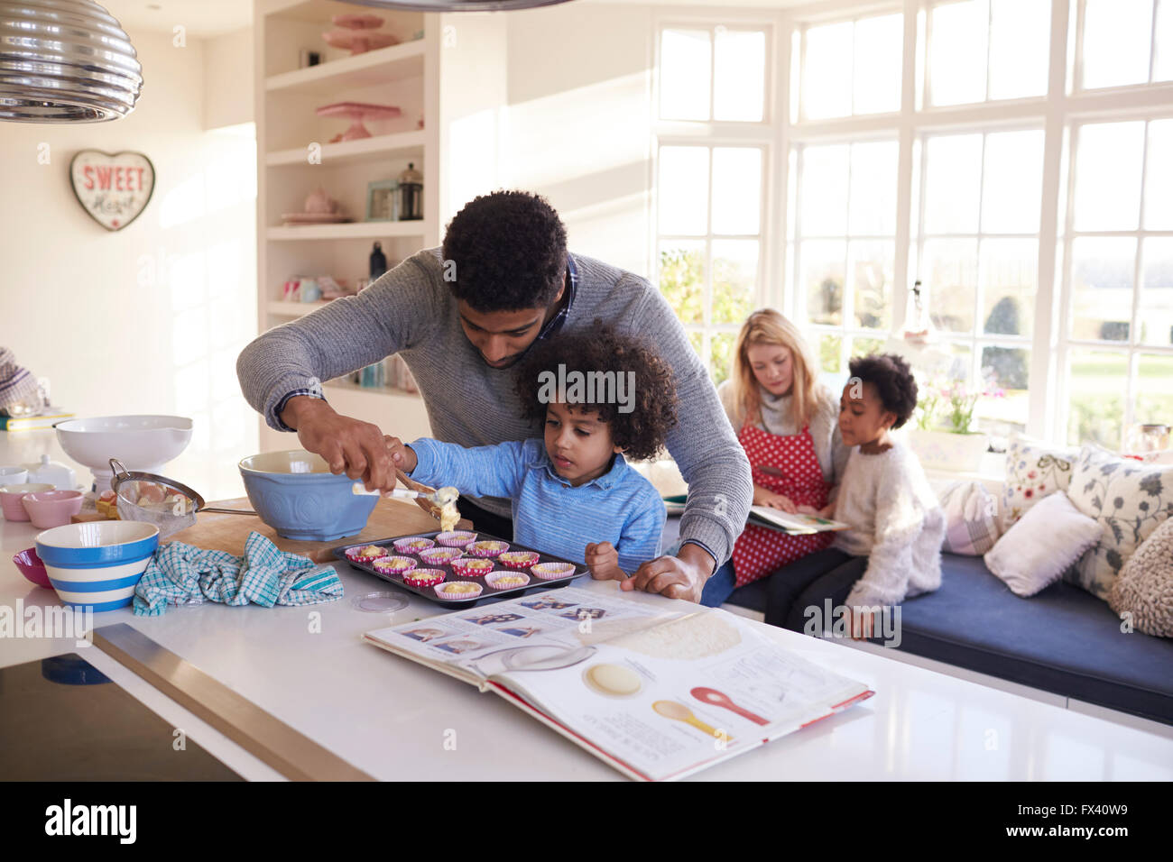 Children mixing ingredients together home hi-res stock photography and ...