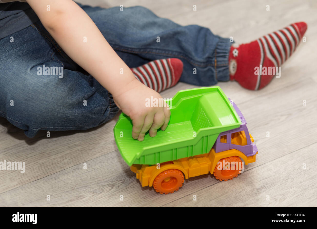 Little boy's hand, holding a toy car, top view Stock Photo - Alamy