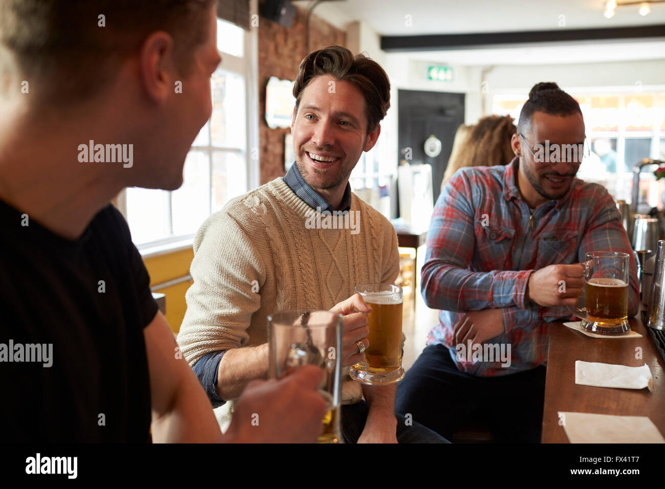 Three Male Friends Enjoying Drink In Bar Stock Photo - Alamy Three Male Friends Enjoying Drink In Bar Stock Photo - Alamy