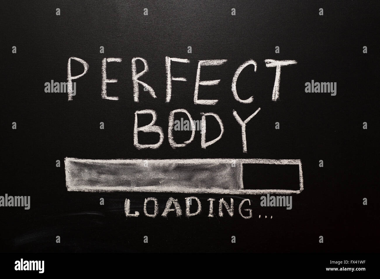 Black chalk desk with perfect body loading picture Stock Photo - Alamy