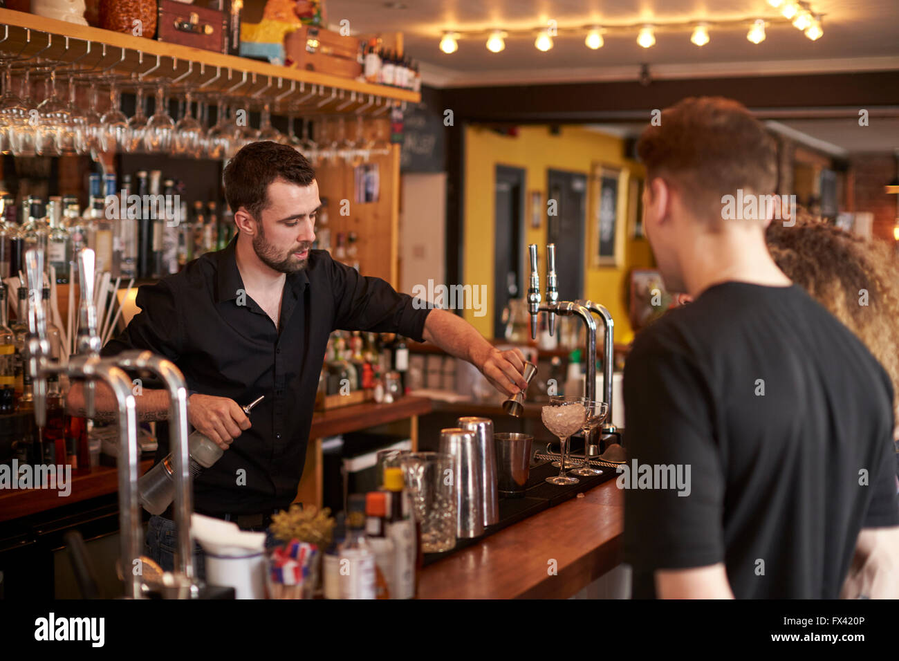 Bartender Giving Cocktail Making Lesson to Friends In Bar Stock Photo ...