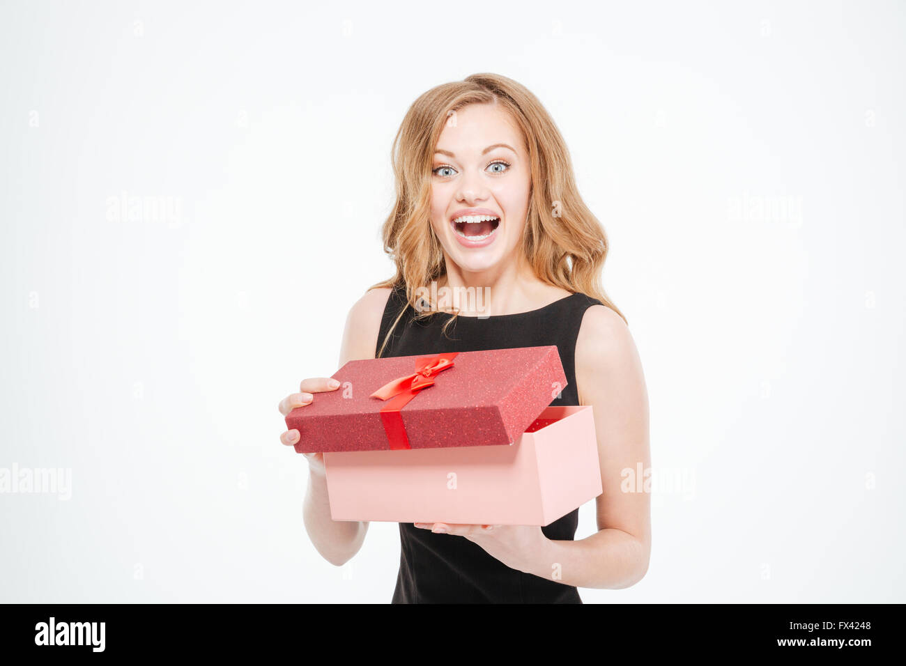 Cheerful woman opening gift box isolated on a white background Stock ...