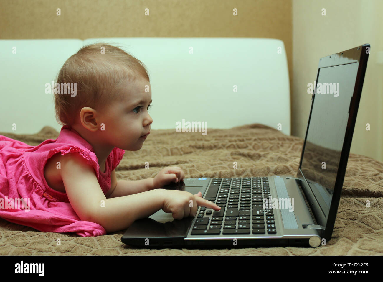 Cute baby working on computer Stock Photo - Alamy