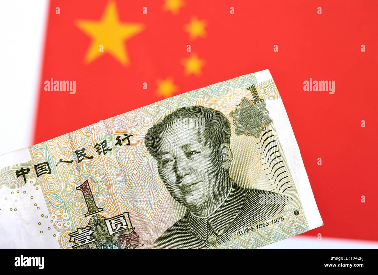 A Chinese Renminbi in front of a Chinese flag Stock Photo - Alamy