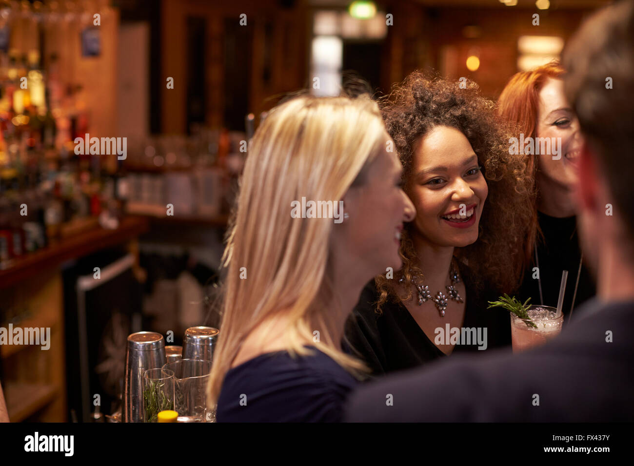 Group Of Friends Meeting For Evening Drinks In Cocktail Bar Stock Photo ...